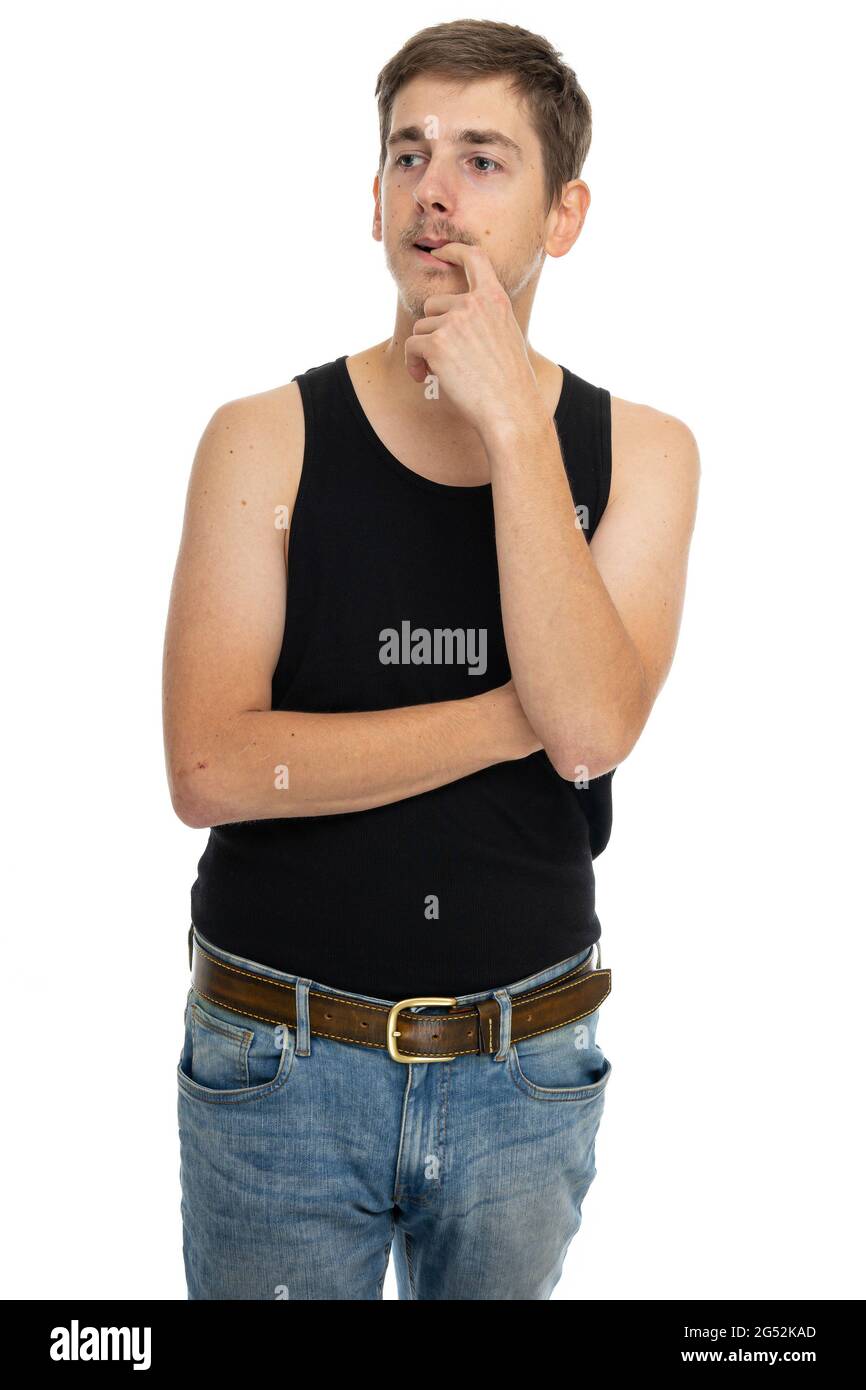 Young handsome tall slim white man with brown hair biting his finger in ...