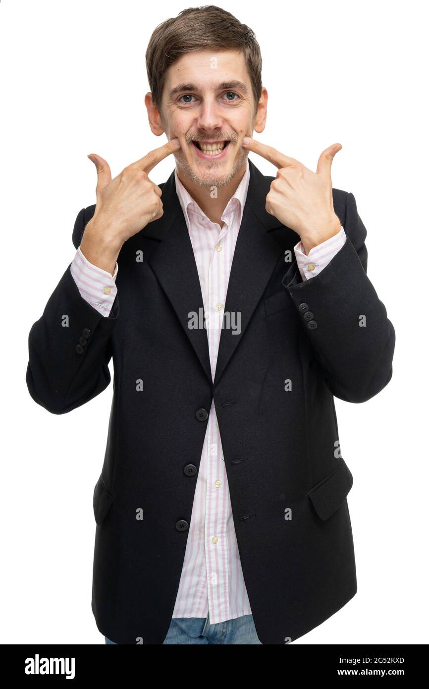 Young handsome tall slim white man with brown hair pointing at his face ...