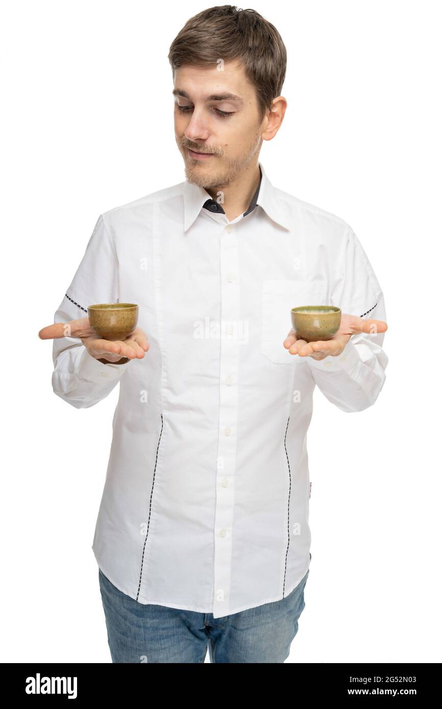 Young handsome tall slim white man with brown hair holding two tea cups ...