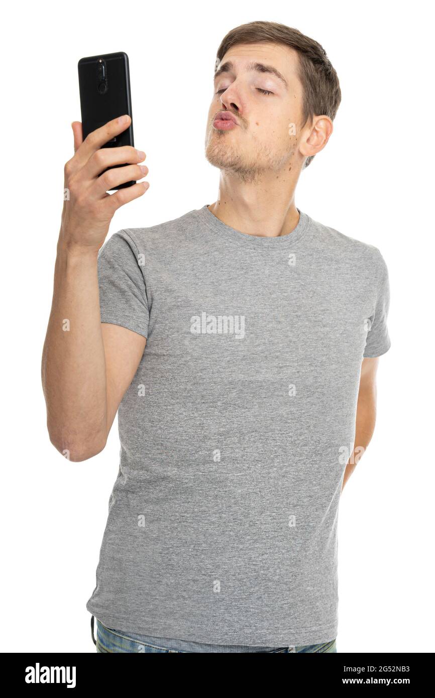 Young handsome tall slim white man with brown hair sending kiss in gray ...