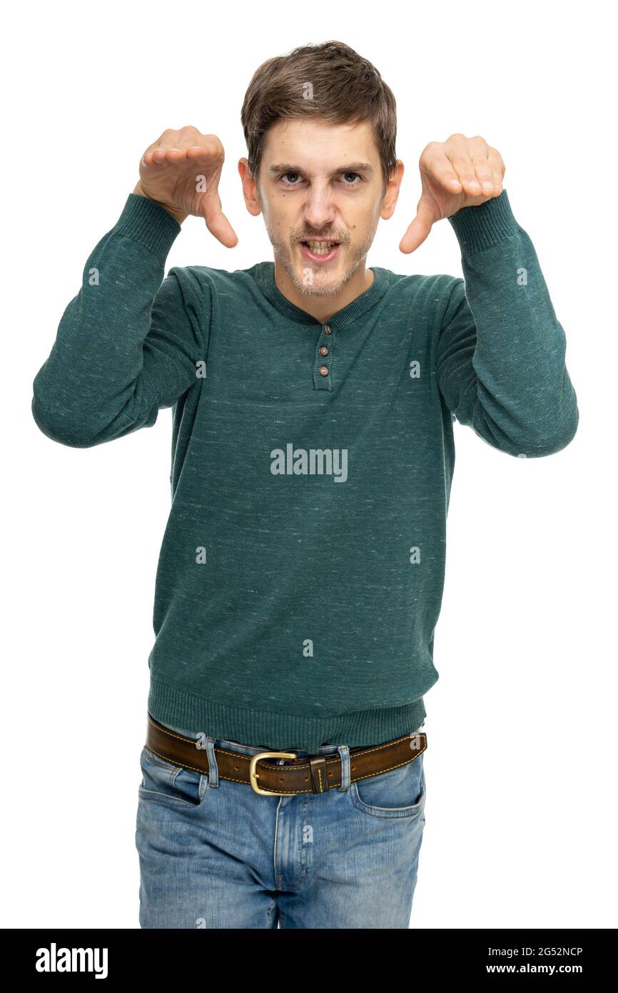 Young handsome tall slim white man with brown hair looks angry in dark ...