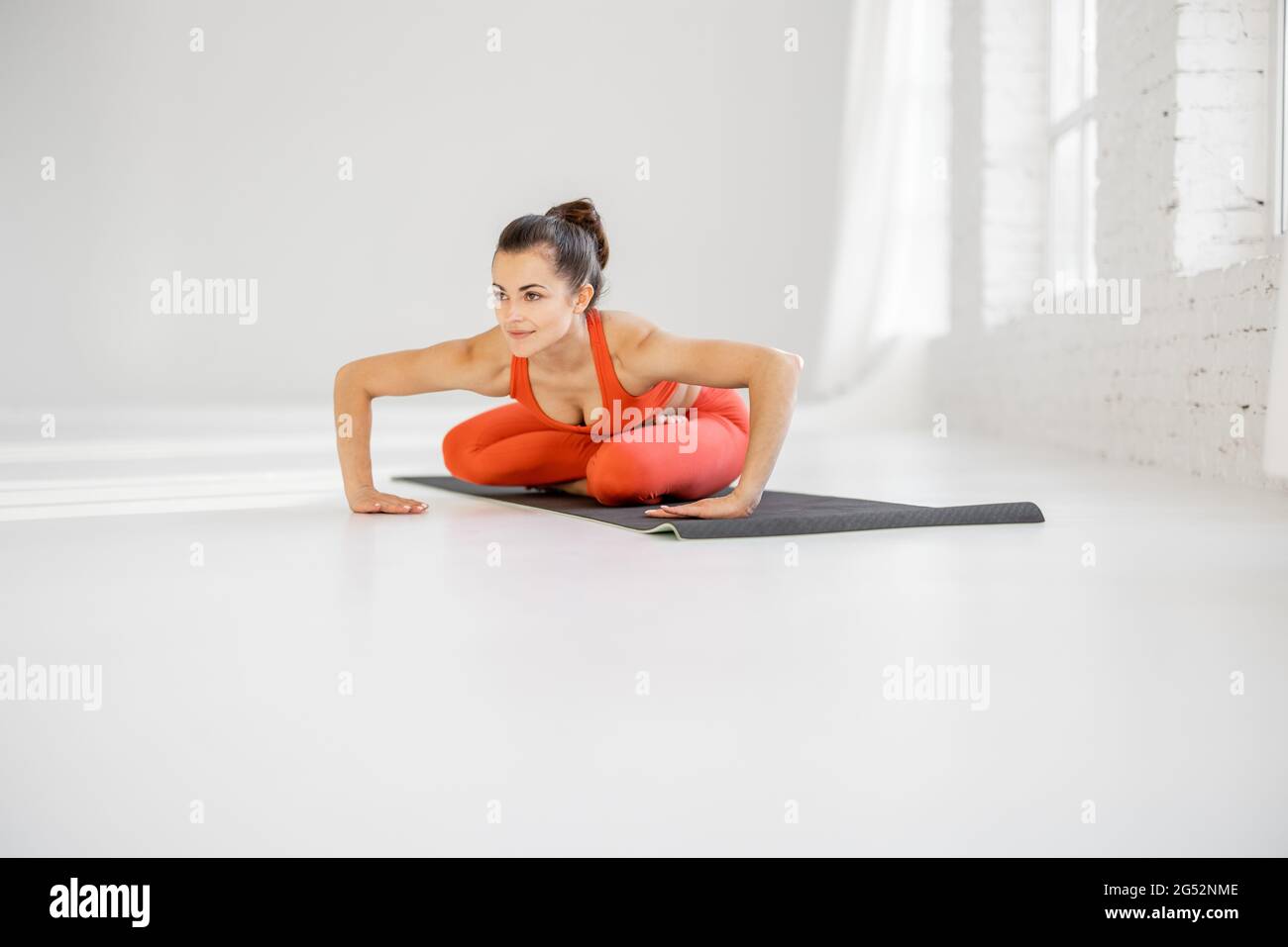 Woman stretching in a yoga pose Stock Photo - Alamy