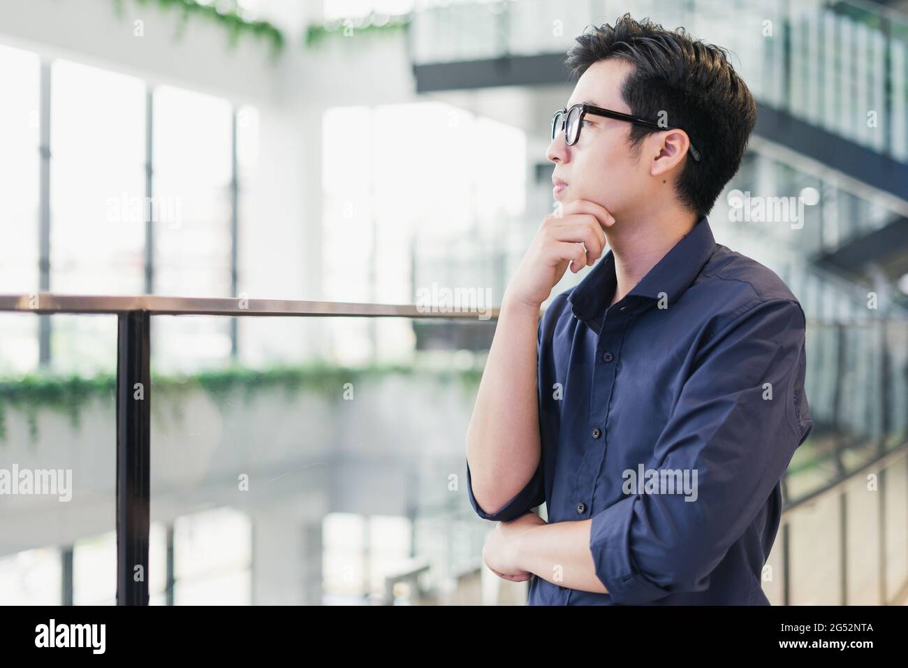 Young man thinking asian hi-res stock photography and images - Alamy