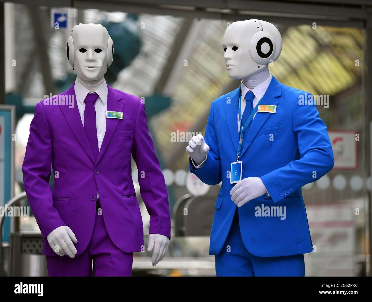Jena, Germany. 25th June, 2021. Two men dressed as robots stand side by ...