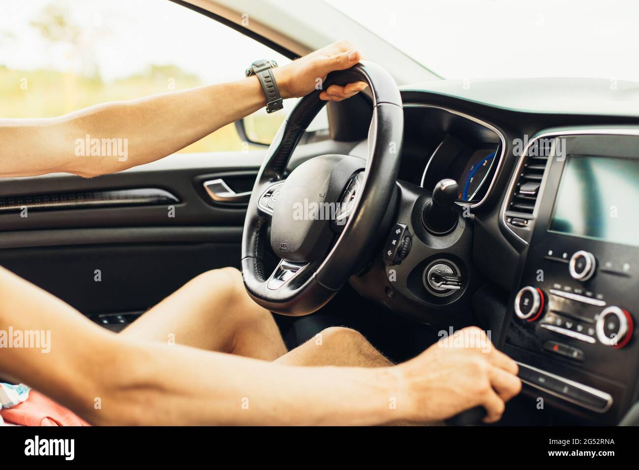 Close-up, driver driving a car, with a view from the inside, a man in ...