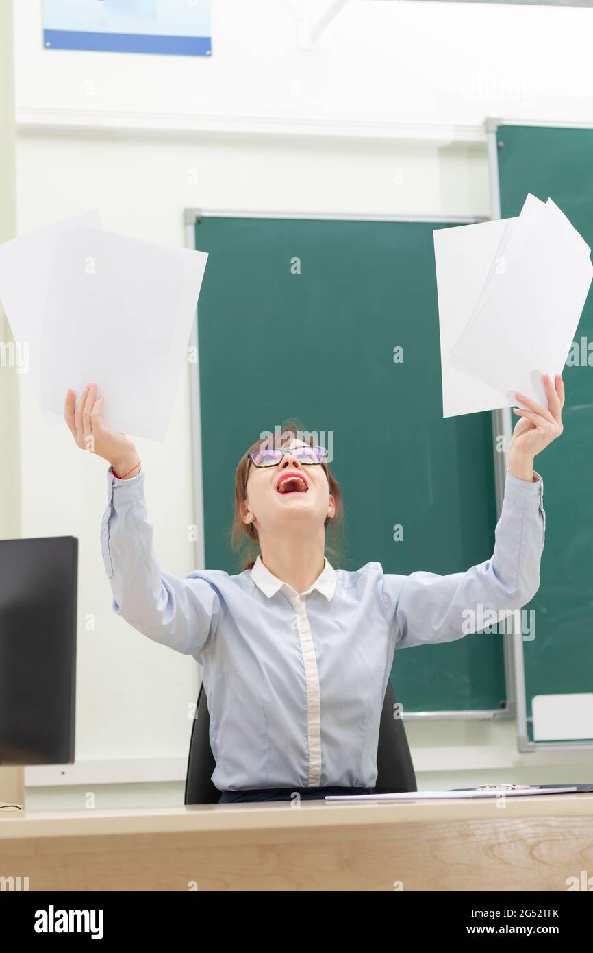 cute young woman teacher at school at her workplace sitting at the ...