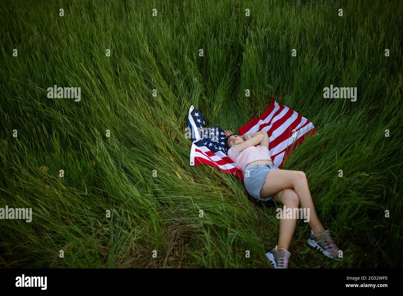 Independence day concept with woman lying down on american flag Stock ...