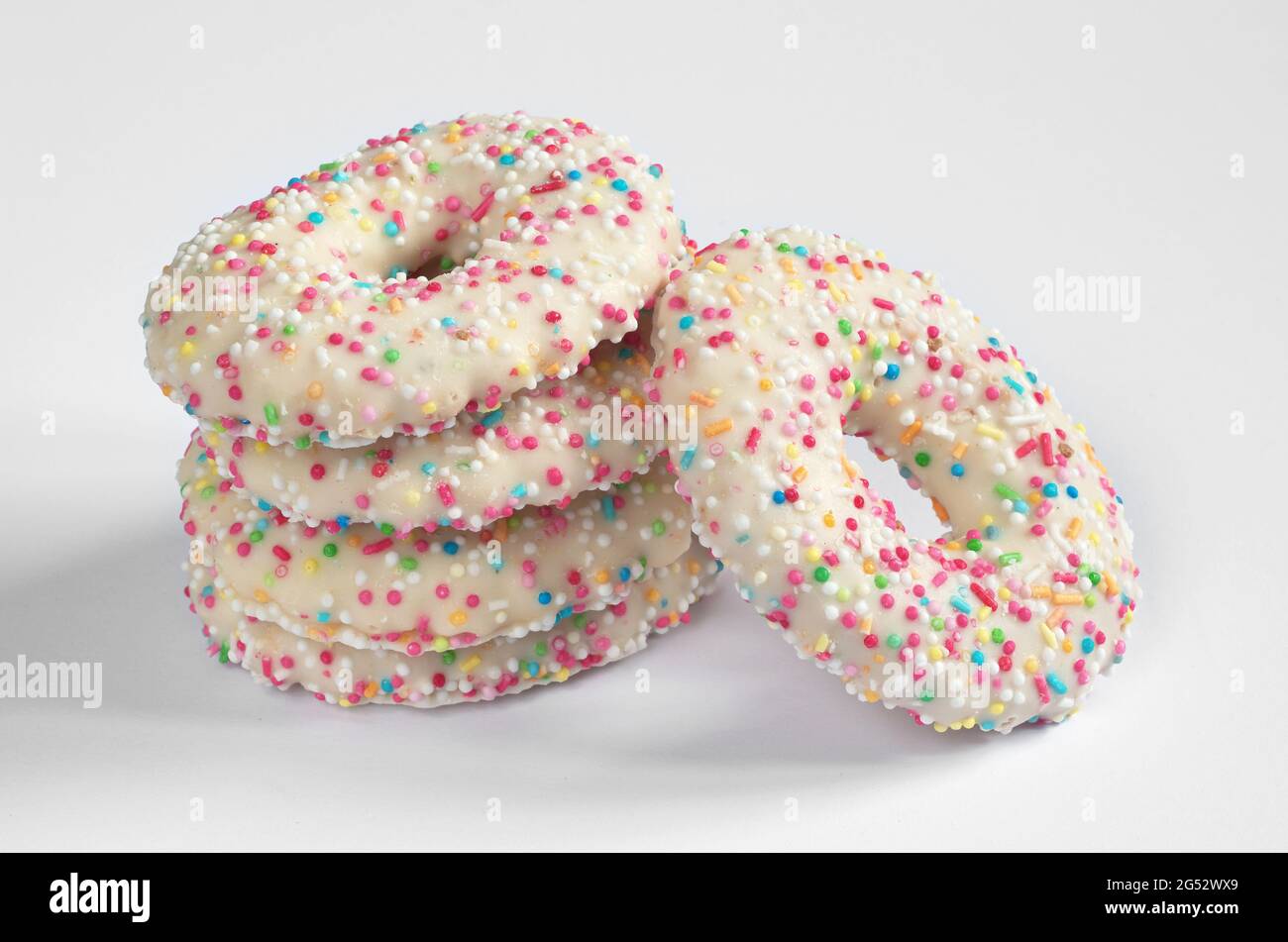 Stack of sugar cookies with sprinkles on white background Stock Photo ...