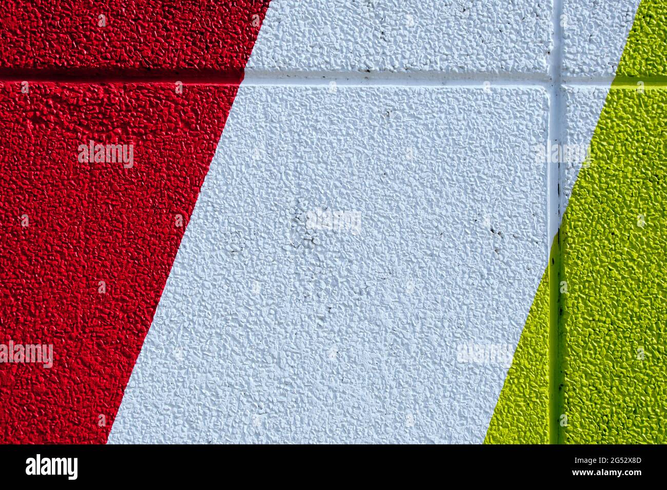 wall of red white and yellow colors on a building exterior Stock Photo ...
