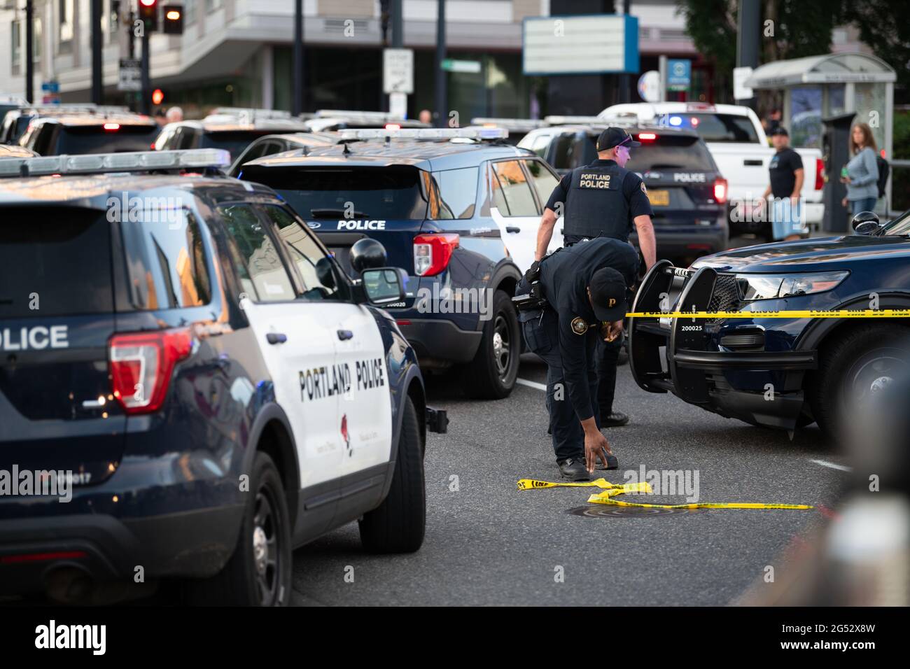 Portland, USA. 24th June, 2021. A police officer picks up severed crime ...