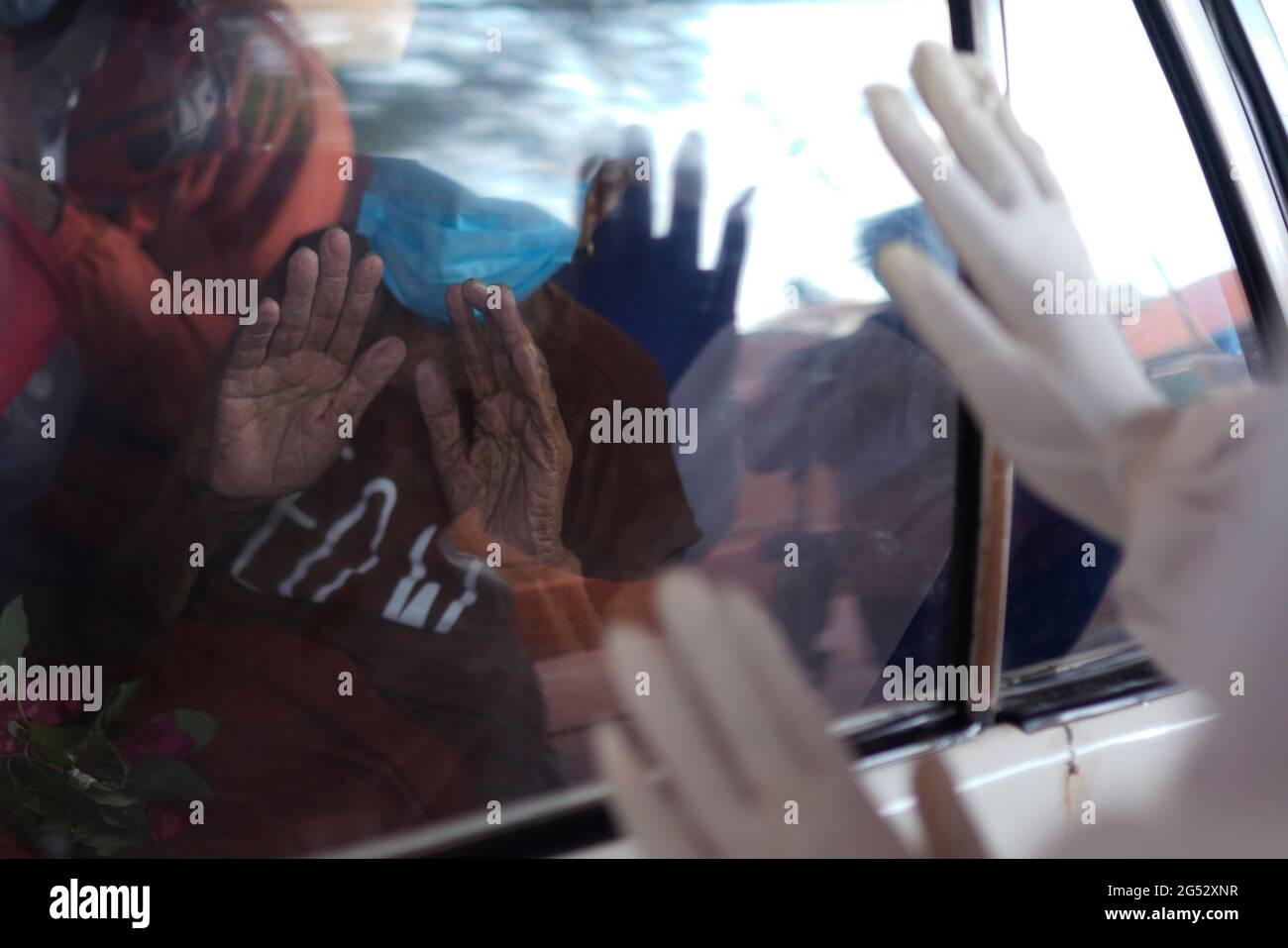 Kathmandu, Nepal. 25th June, 2021. A 92 years old Kalika Devi Bastola gestures to a health ...