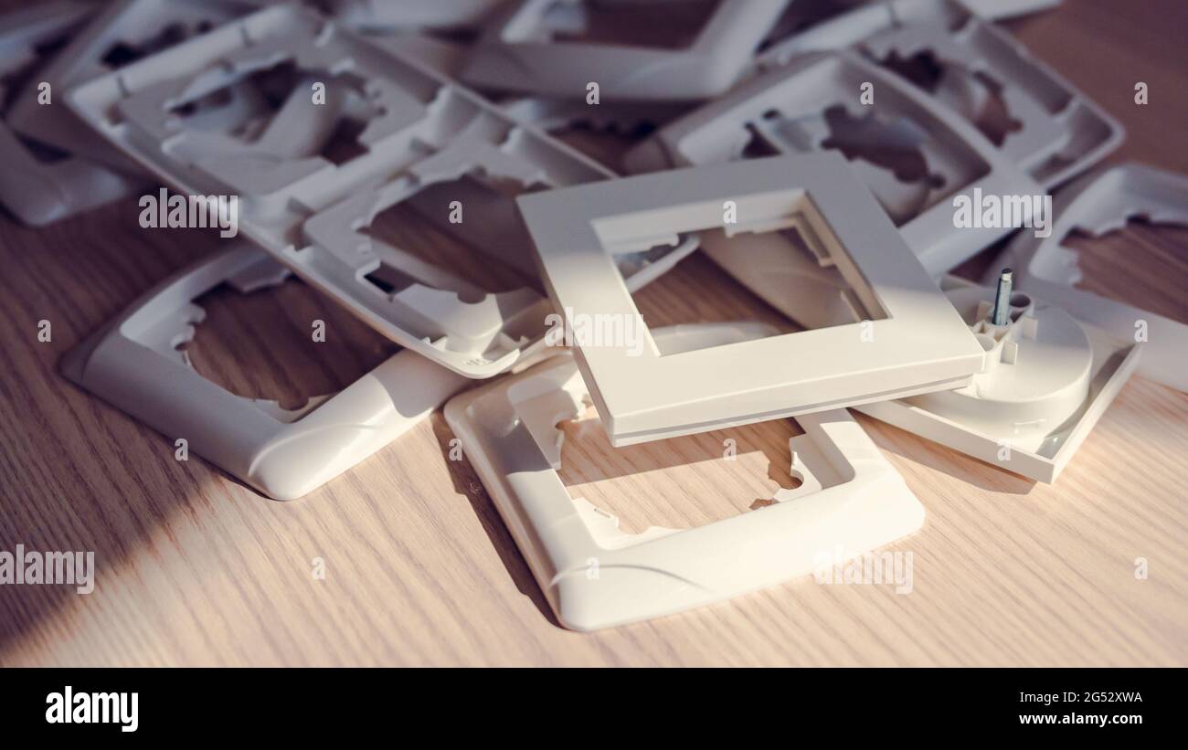 The stack of socket frames on the light wooden table Stock Photo - Alamy