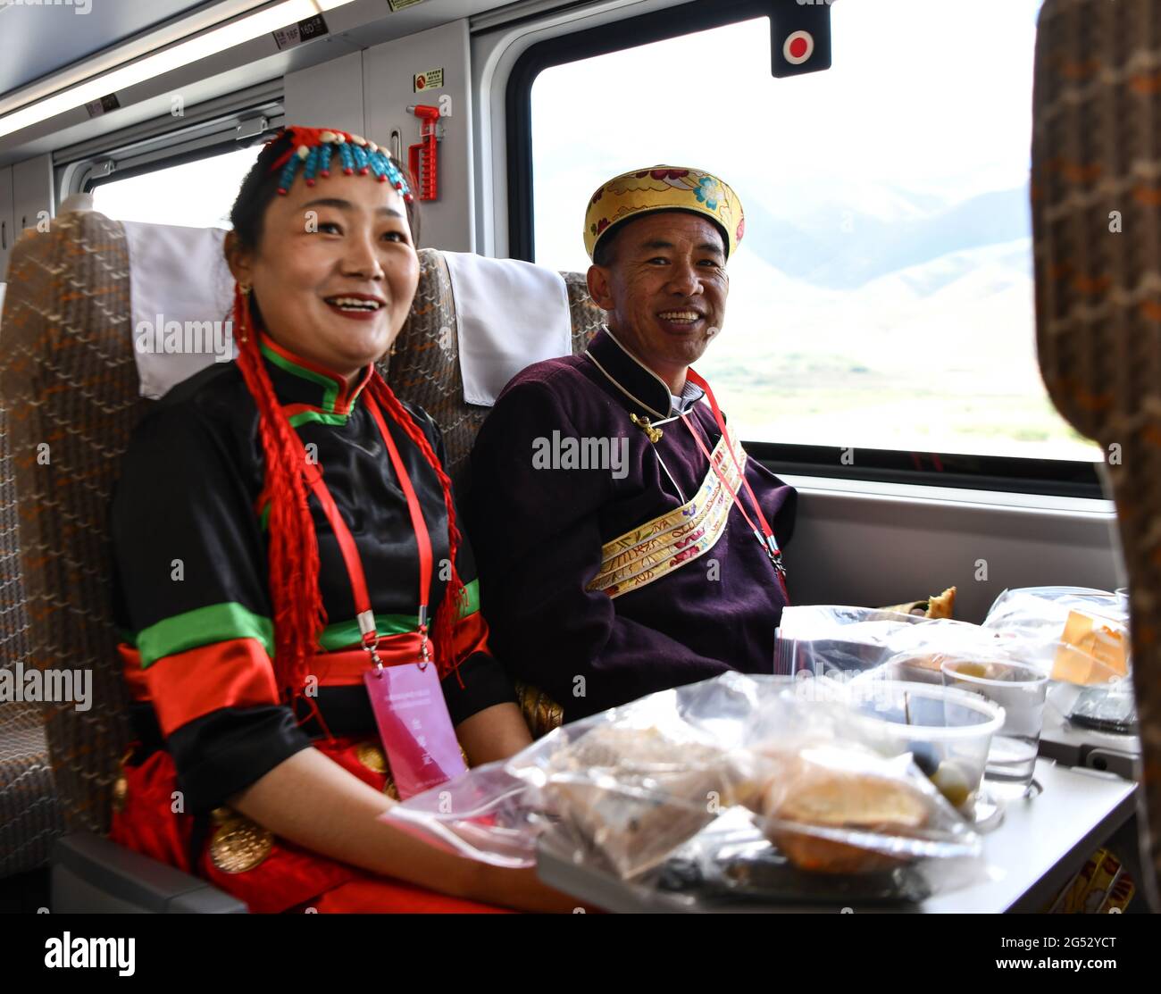 Lhasa. 25th June, 2021. Passengers aboard the Fuxing bullet train are ...