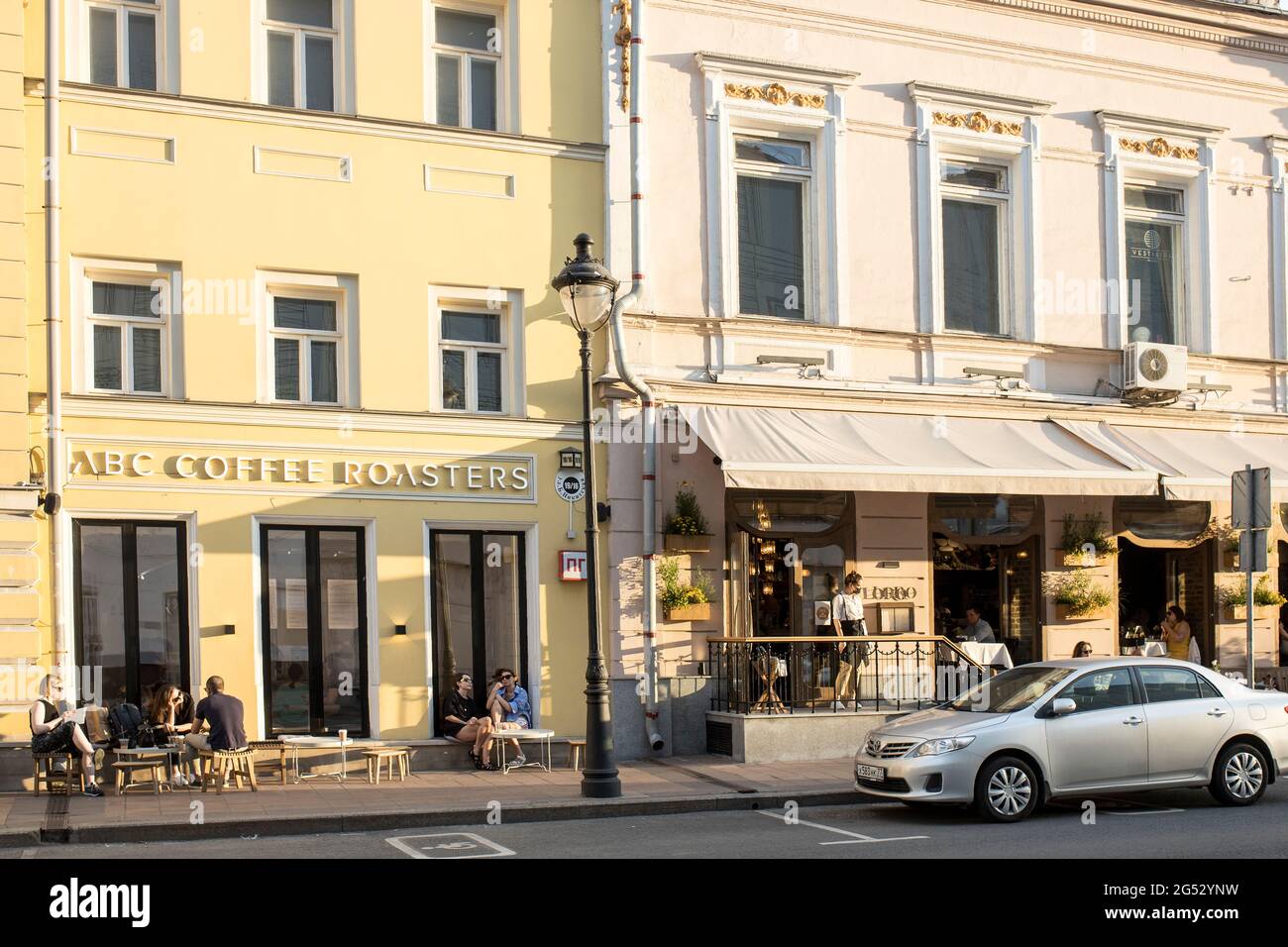 Moscow, Russia - 21 June 2021, People sit at tables on the street ...