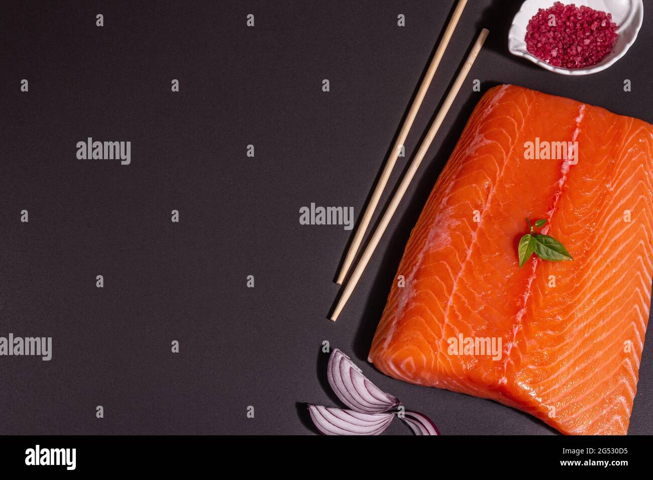 Fresh raw salmon or trout sea fish fillet on black stone background ...