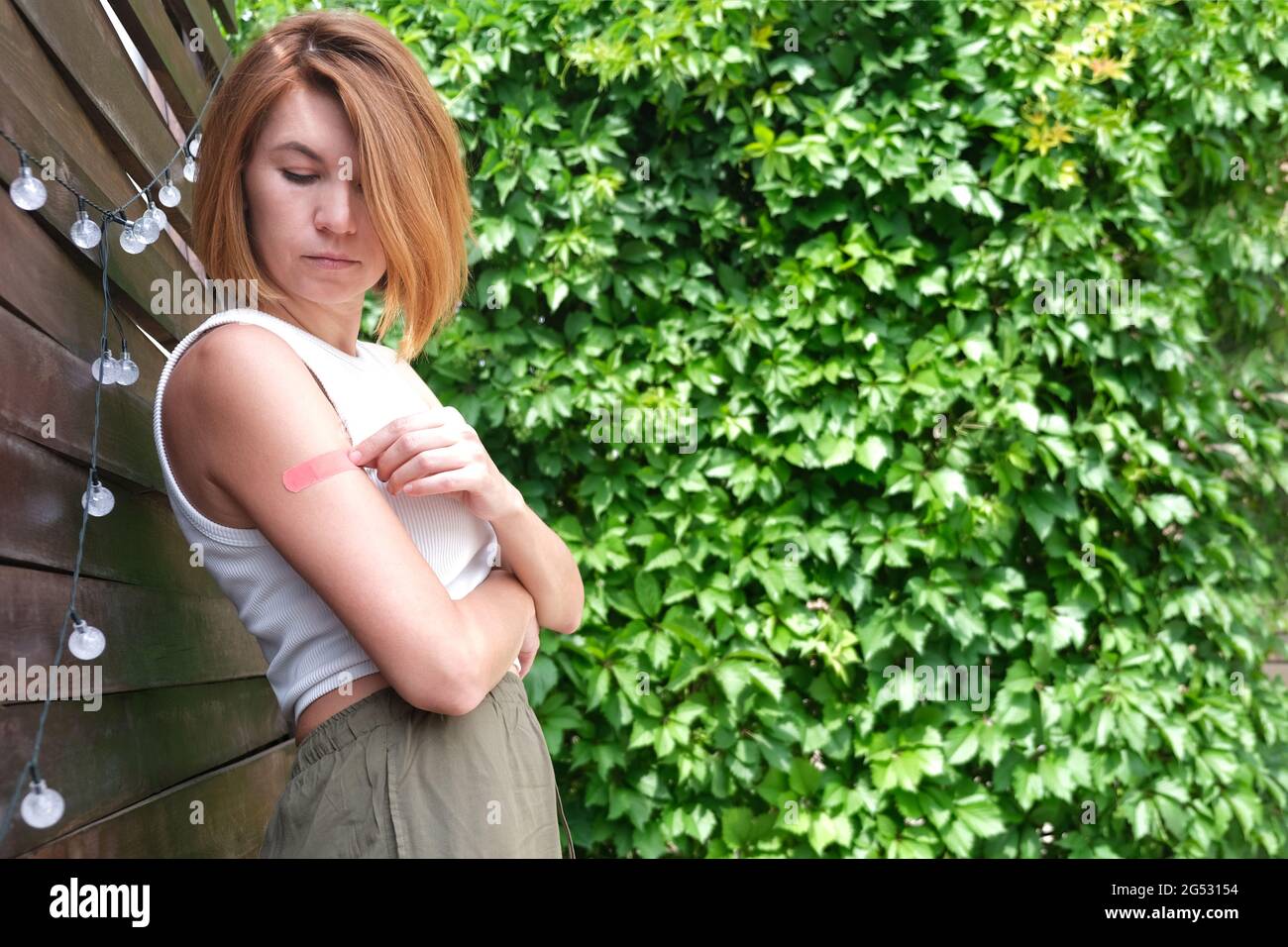 Smiling woman glasses with a plaster on her hand rejoices from ...