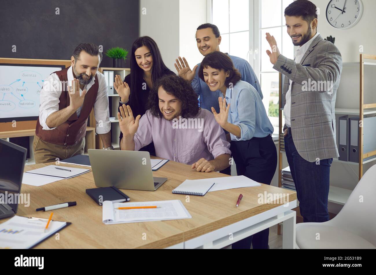 Happy business colleagues team greeting while having online meeting via ...