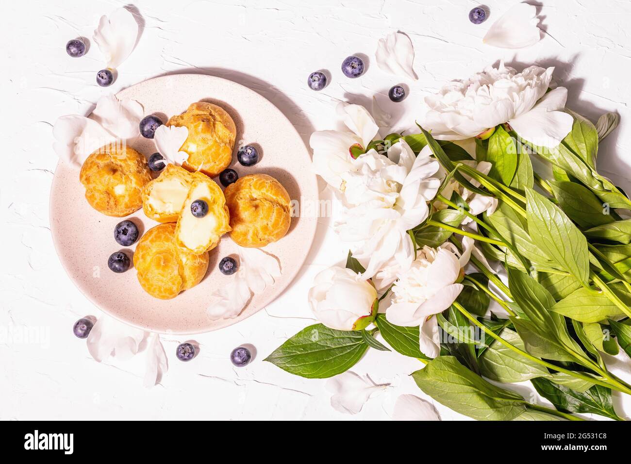 Profiteroles with blueberries. Custard cakes, Eclair, cream puff ...