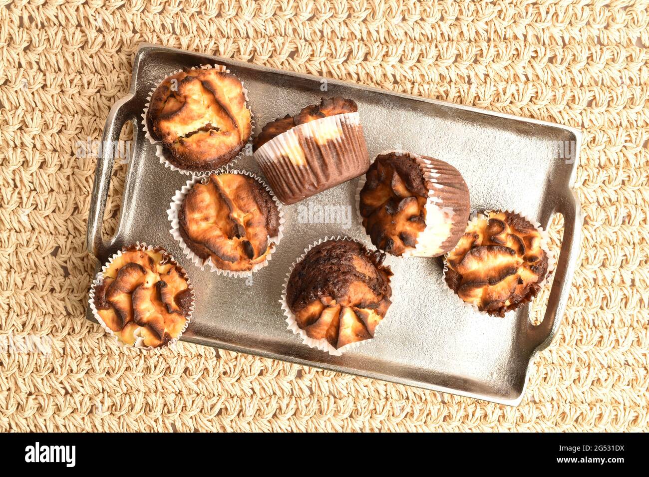 Several fragrant chocolate curd muffins on a metal tray, close-up, on a ...