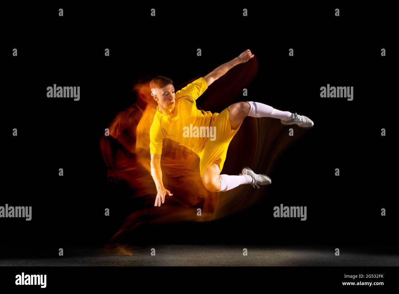 Falling. One caucasian male football or soccer player training with ...