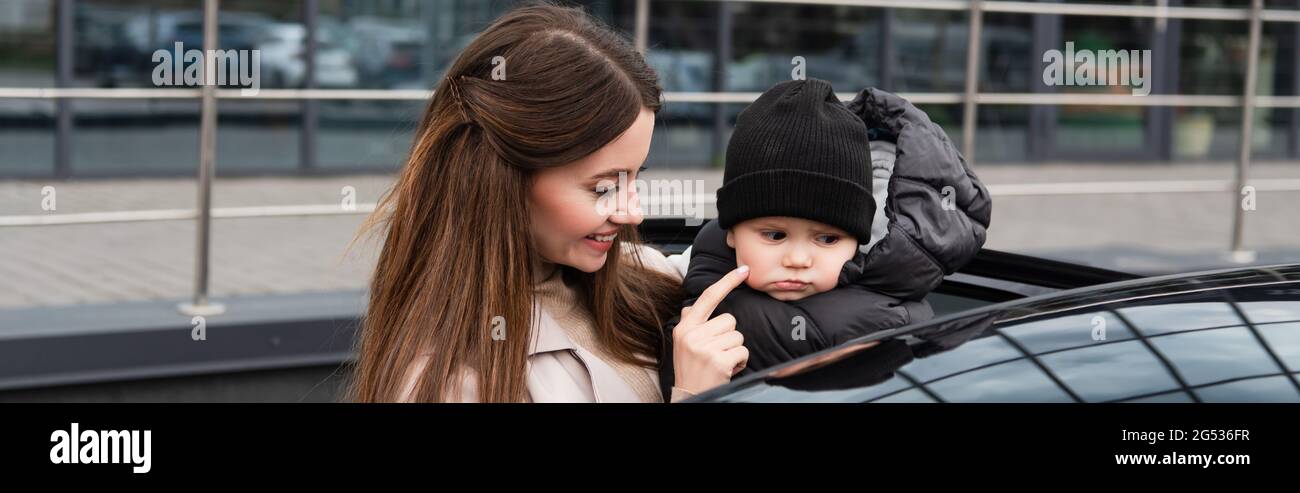 Mother touching baby cheek hi-res stock photography and images - Alamy