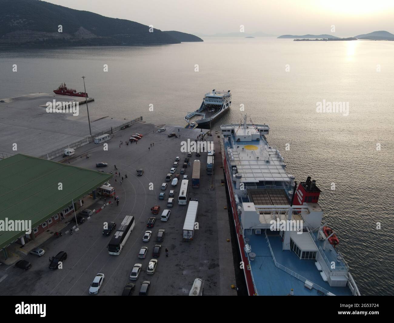aerial view cars lorries waiting to be loaded In ferry ships at dock in ...