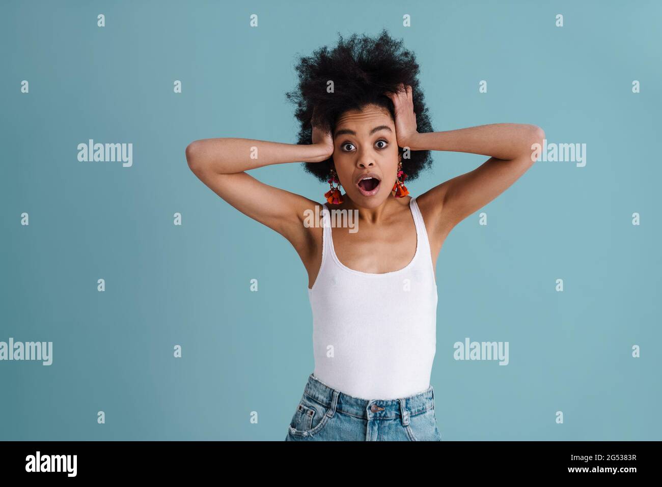 Shocked african american girl grabbing her head and looking at camera ...