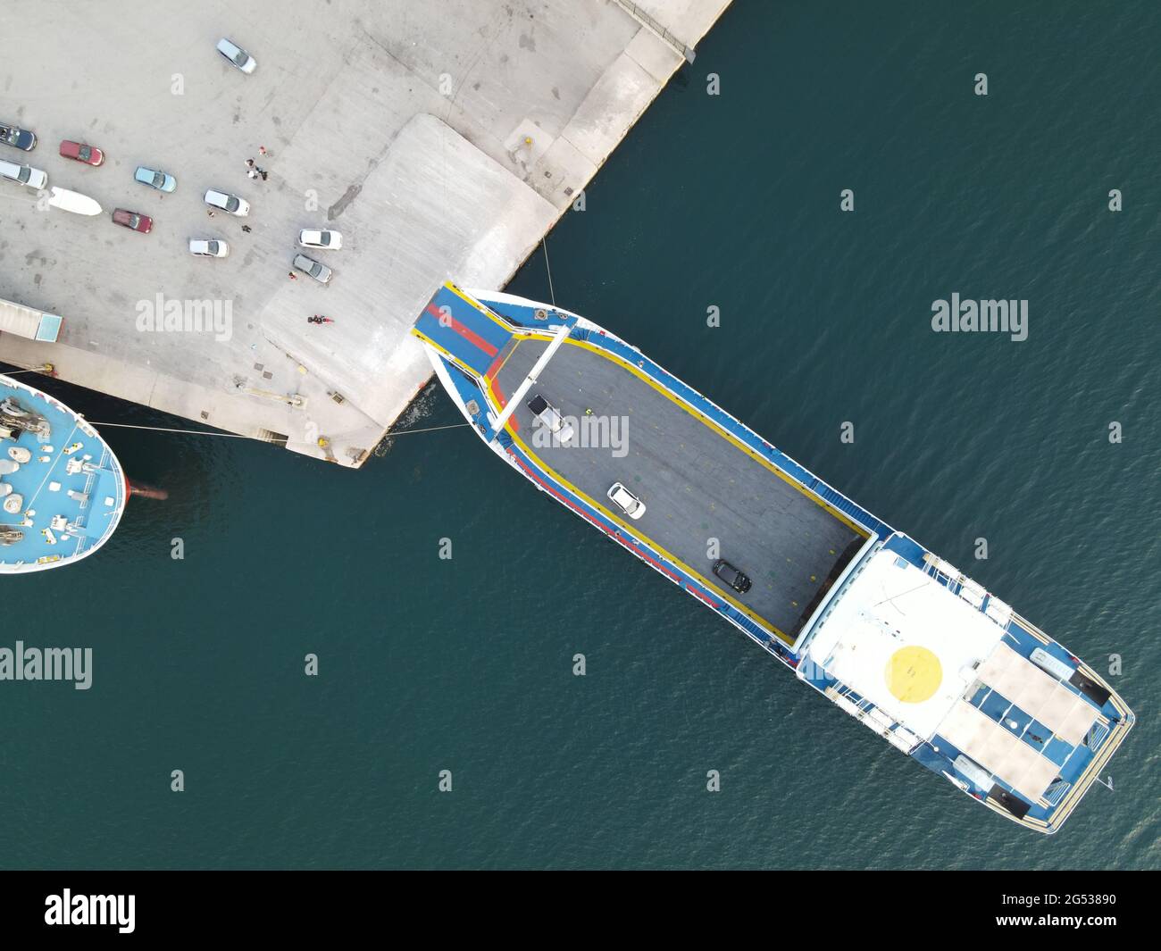 aerial view cars lorries waiting to be loaded In ferry ships at dock in ...