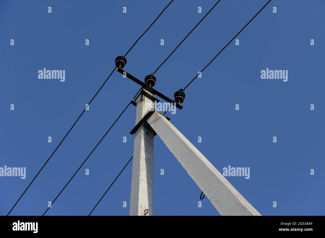 Electric post with blue sky background Stock Photo - Alamy