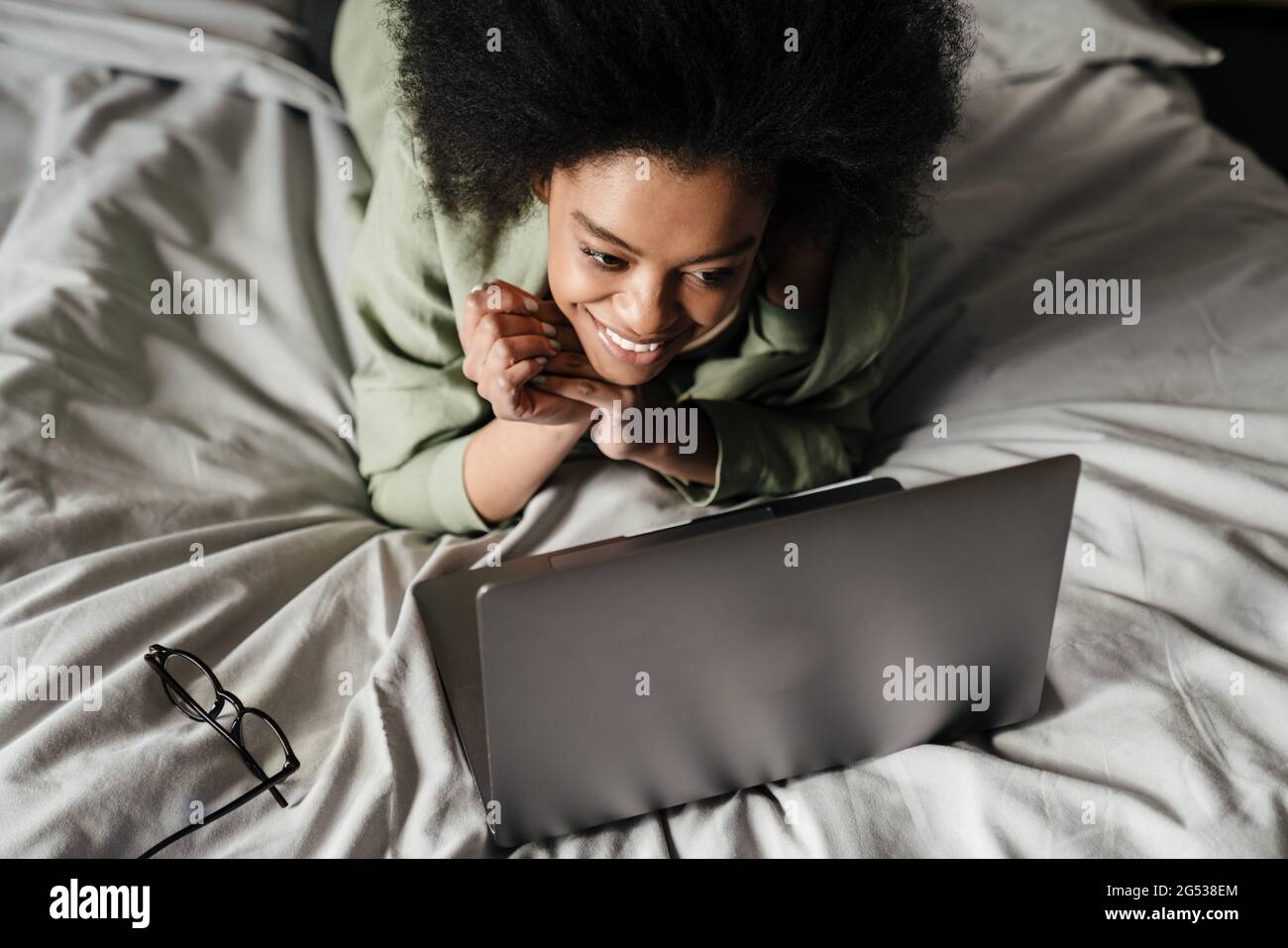 African woman laying in bed hi-res stock photography and images - Alamy