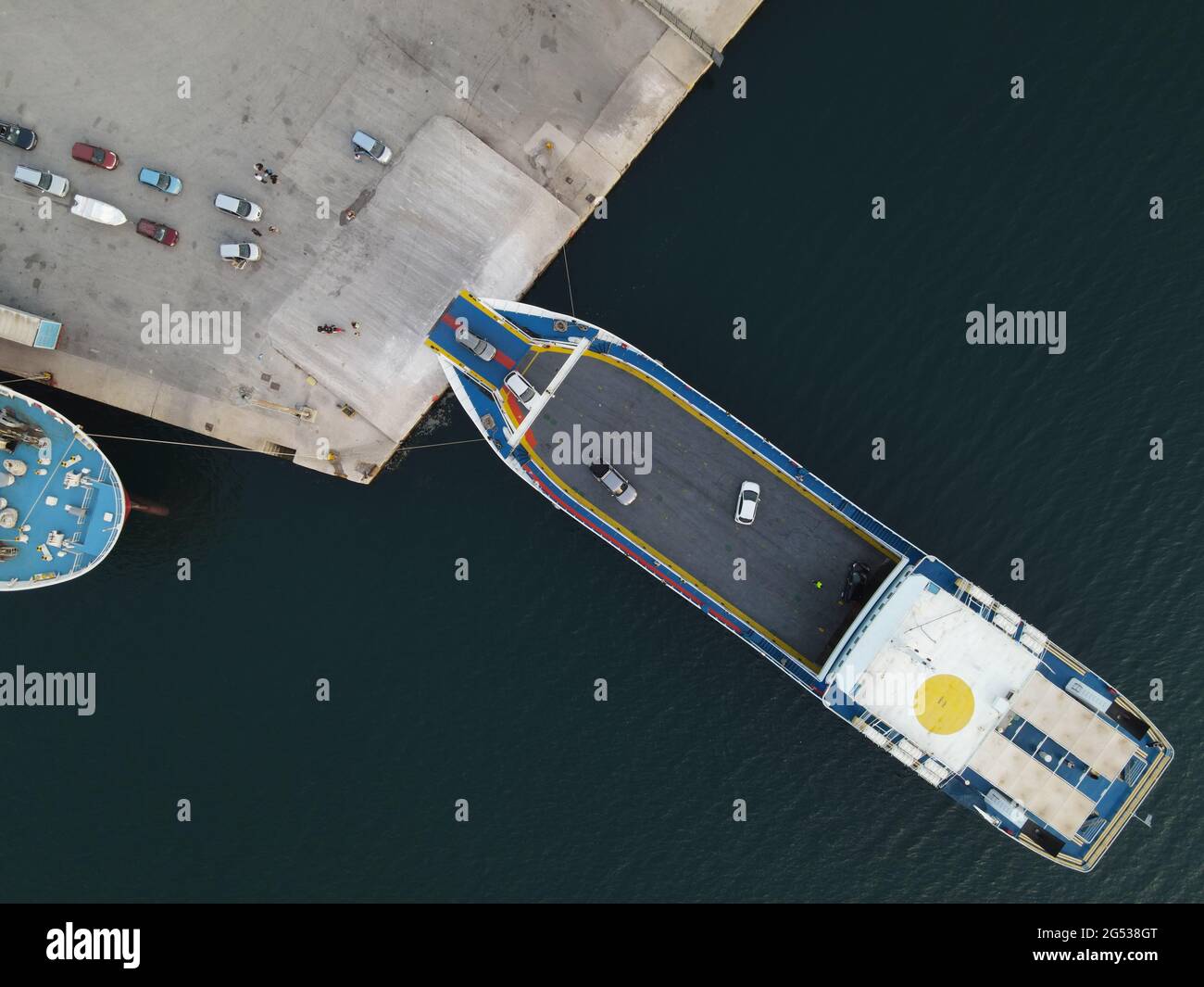 aerial view cars lorries waiting to be loaded In ferry ships at dock in ...