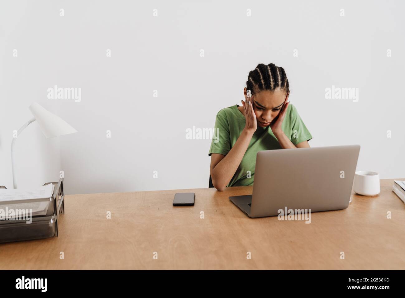 Black young woman with headache working with laptop while sitting at ...
