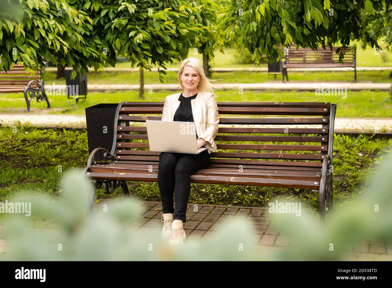 Image of elegant employer sitting on the bench Stock Photo - Alamy
