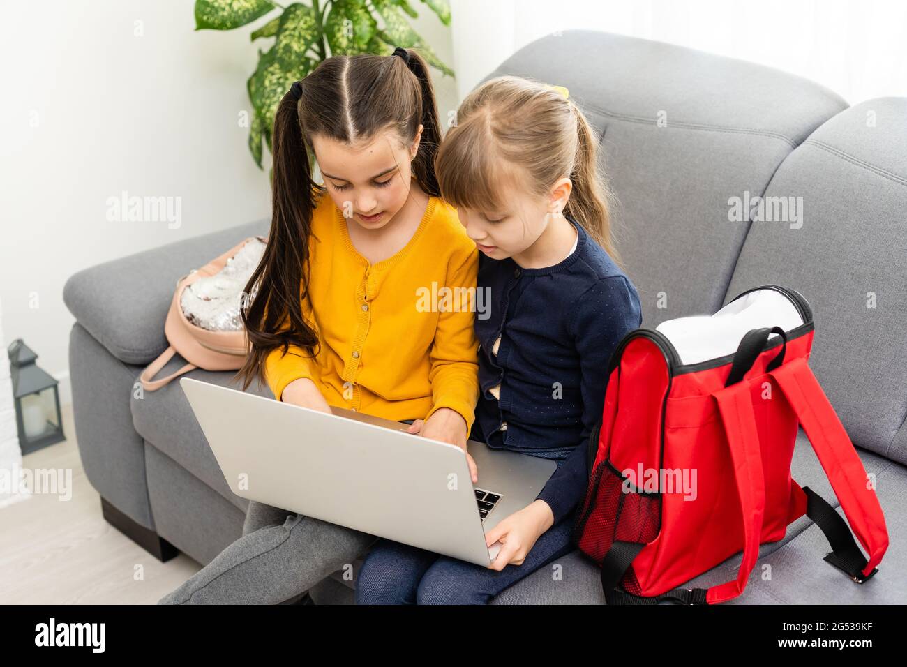 Cute girl friends laughing at laptop computer screen, hugging Stock ...