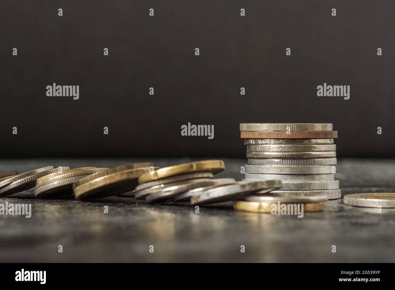 A close-up of various coins stacked on top of each other in ascending ...