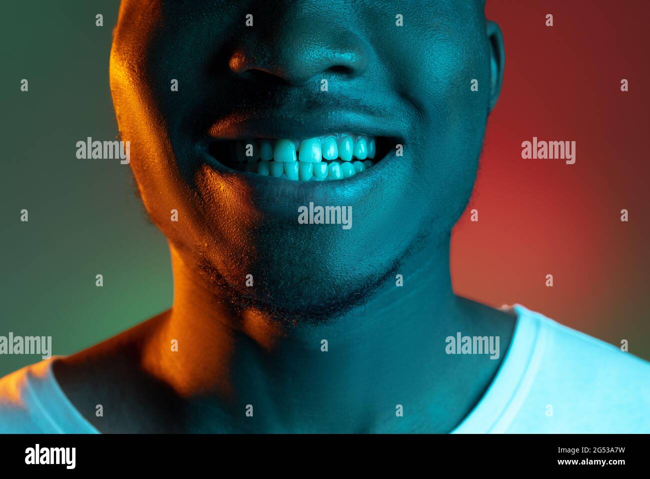 Cropped image African young man's portrait on bright studio background ...