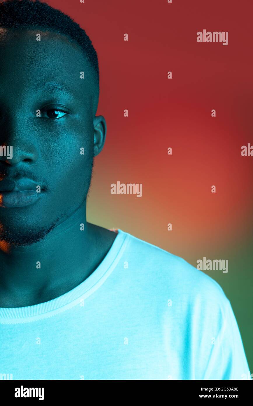 Close up. African young man's portrait on bright studio background in ...