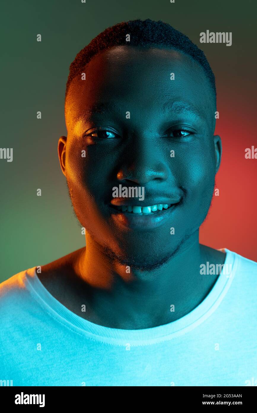 Close up. African young man's portrait on bright studio background in ...