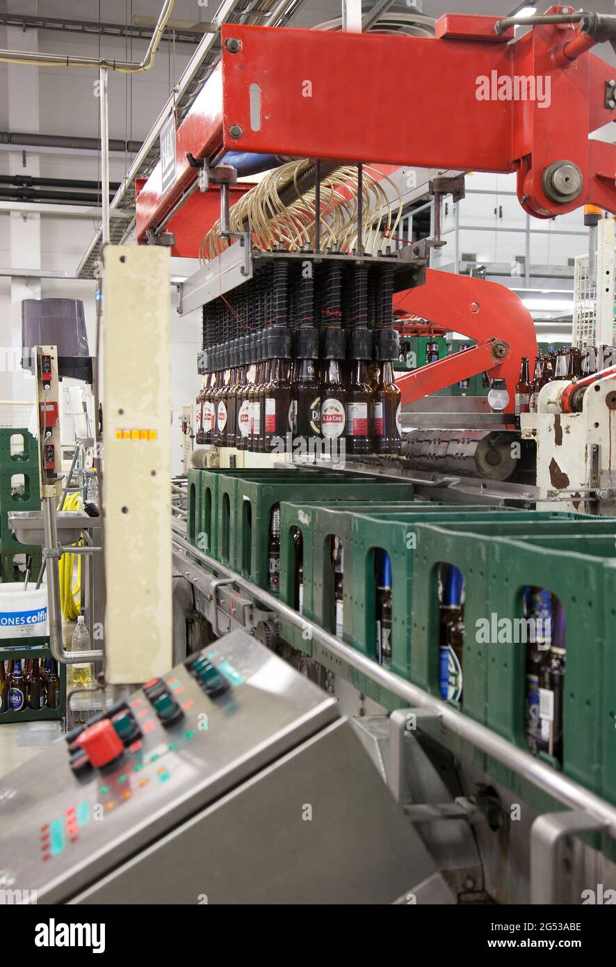 Bottling plant with moving belts, rows of bottles, automated process ...