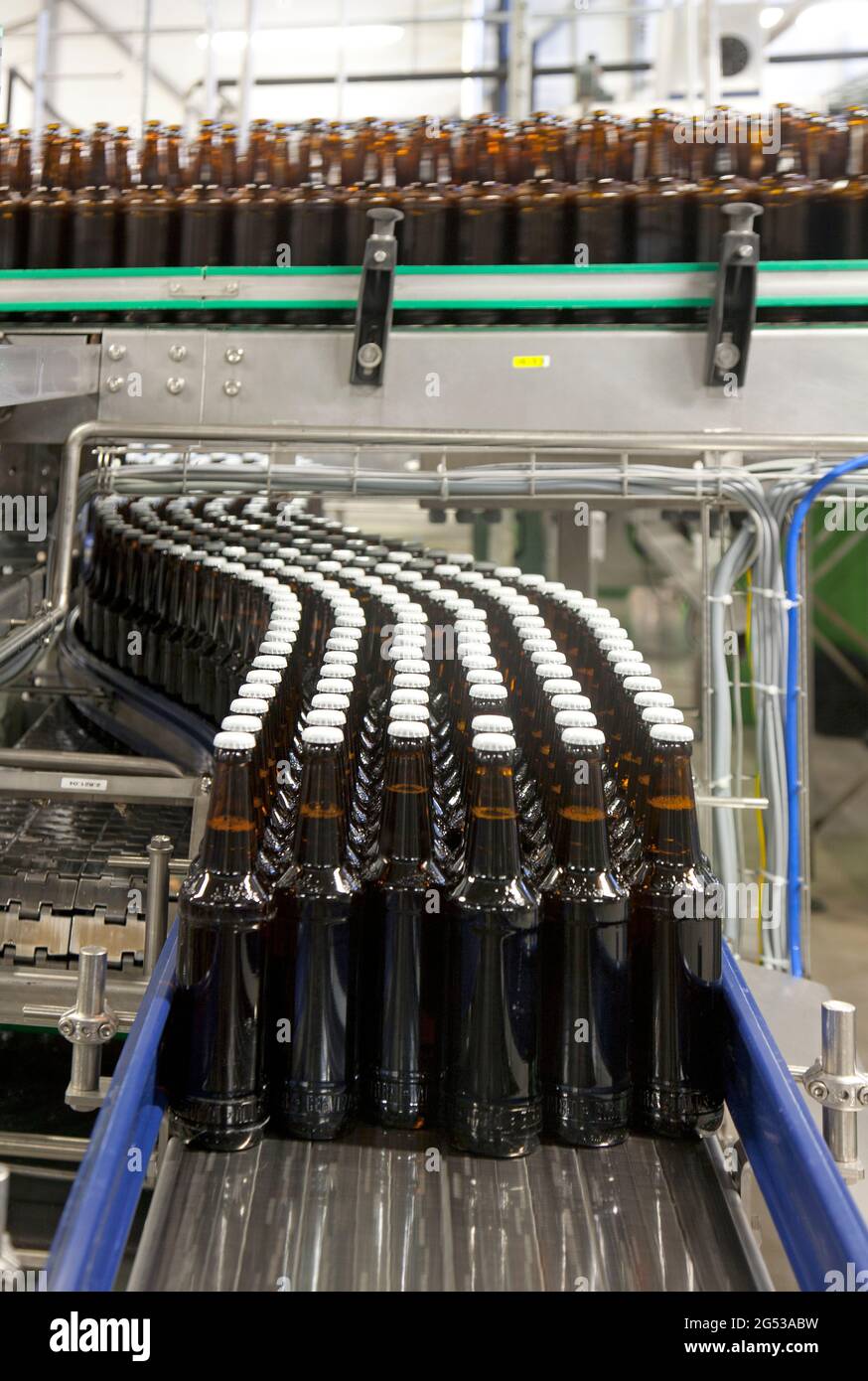 Beer bottling plant with moving belts, rows of bottles, automated ...