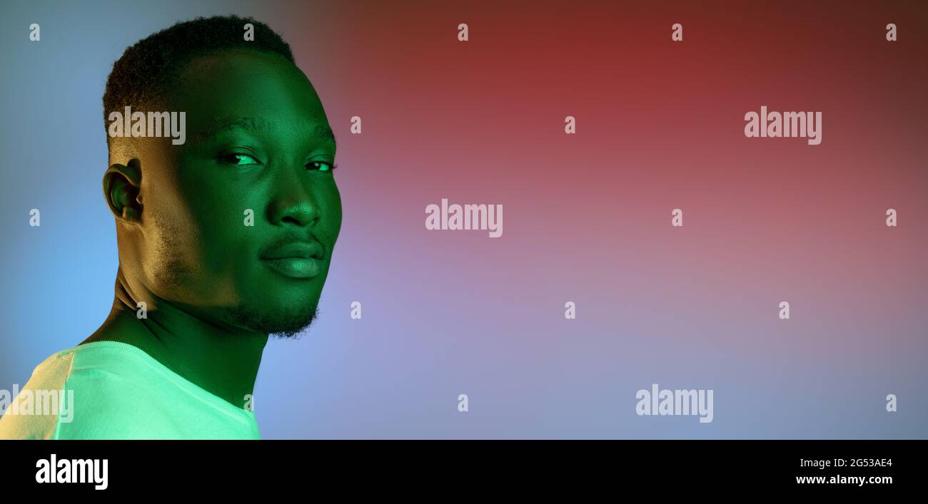 Close up portrait of african young man on bright studio background in ...