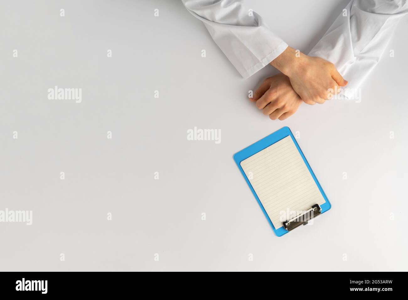 top view of doctor hands holding a sheet paper to write down the recipe ...