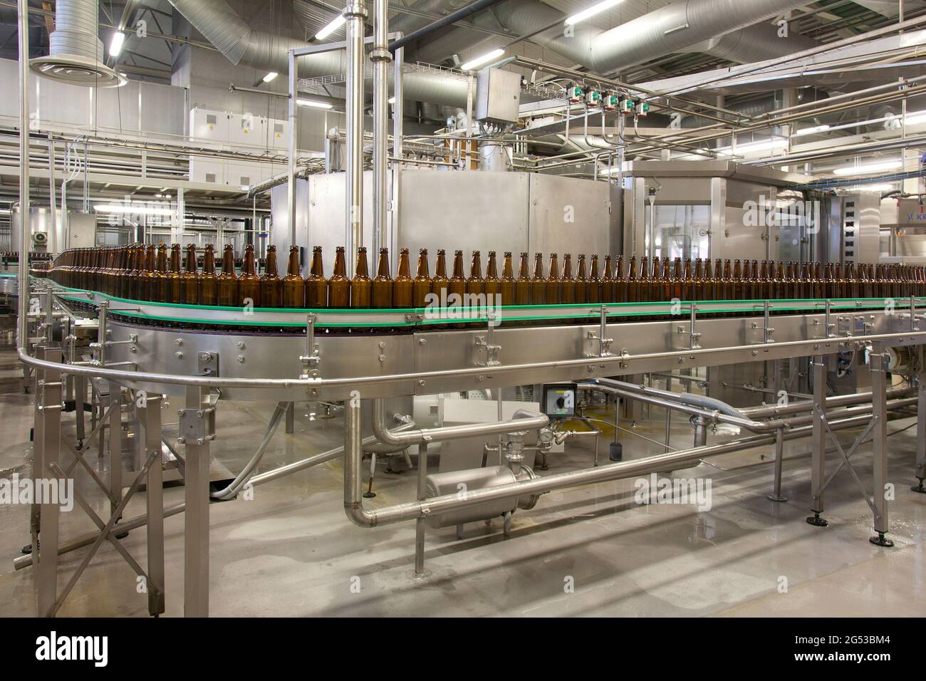 Beer bottling plant with moving belts, rows of bottles, automated ...