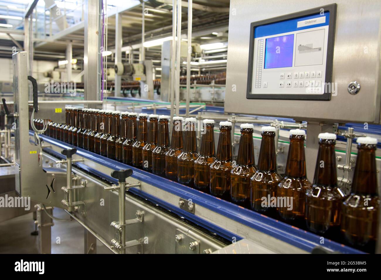 Beer bottling plant with moving belts, rows of bottles, automated ...