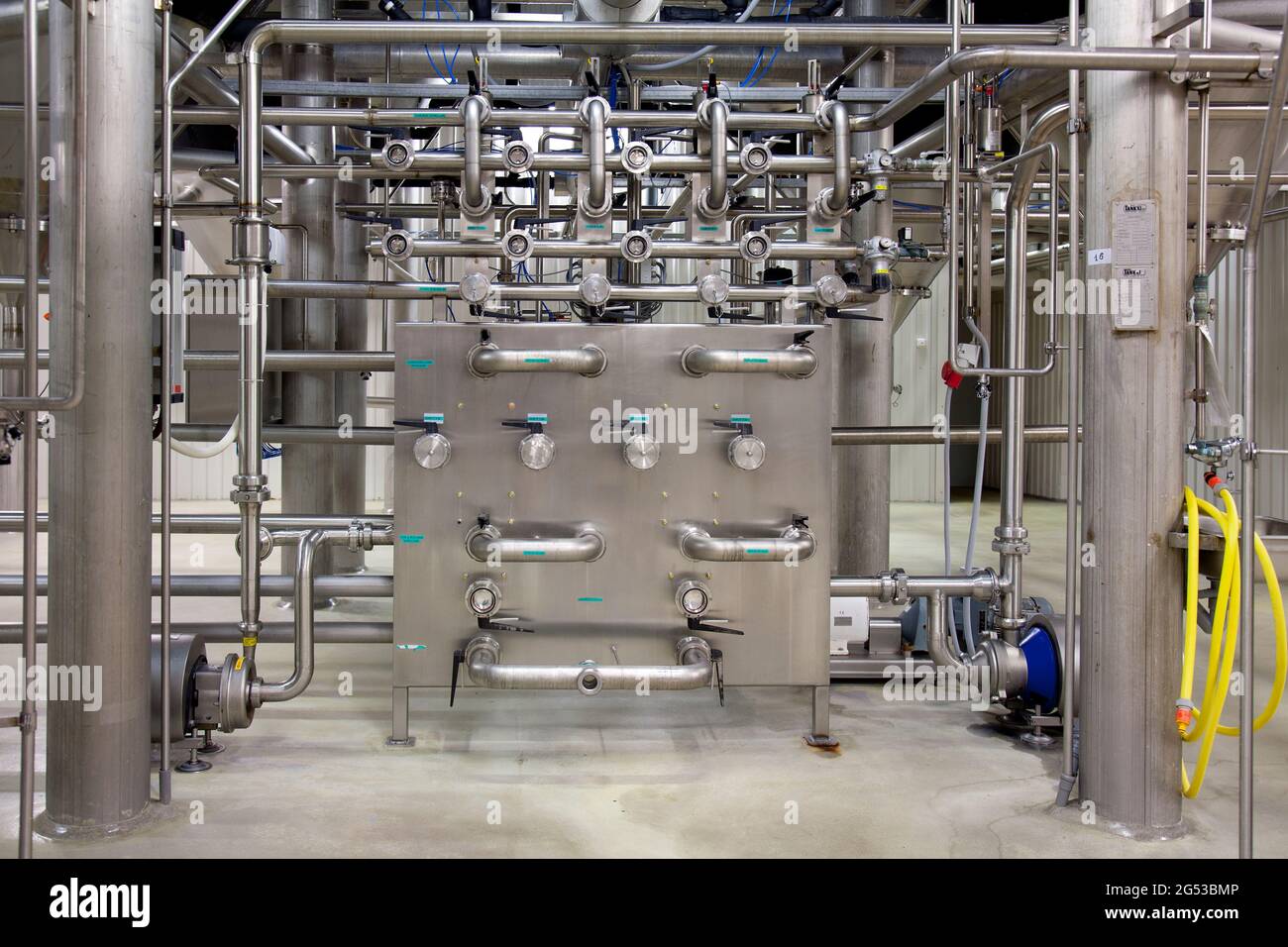 Interior of brewery, large steel pipes, valves and control unit for the ...