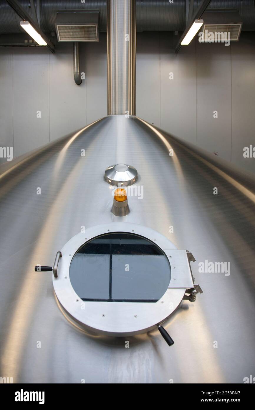 Interior of brewery, large steel storage tanks for brewing beer ...