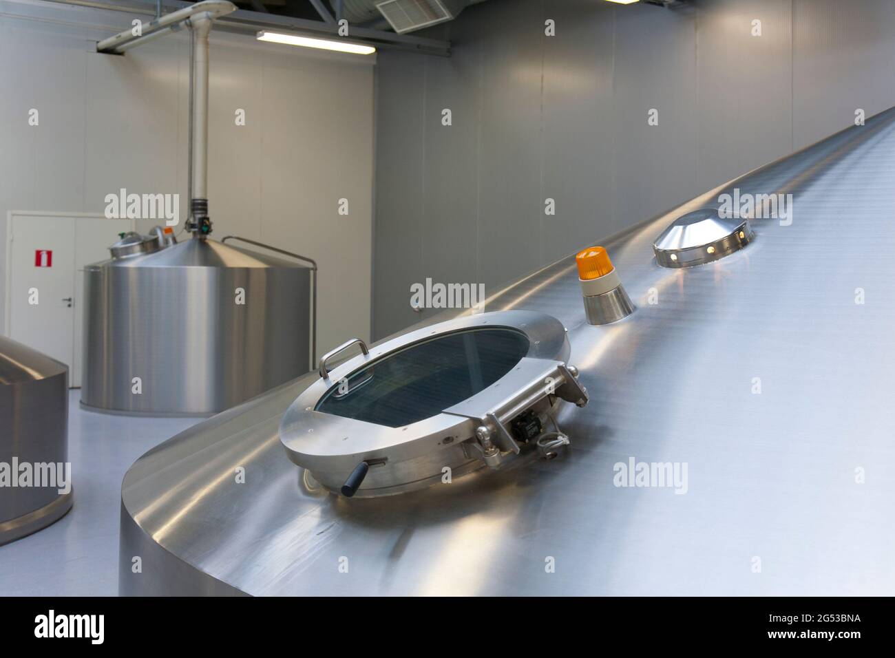 Interior of brewery, large steel storage tanks for brewing beer ...