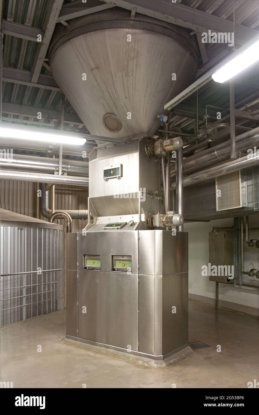 Interior of brewery, hopper and metal mashing tanks for brewing beer ...