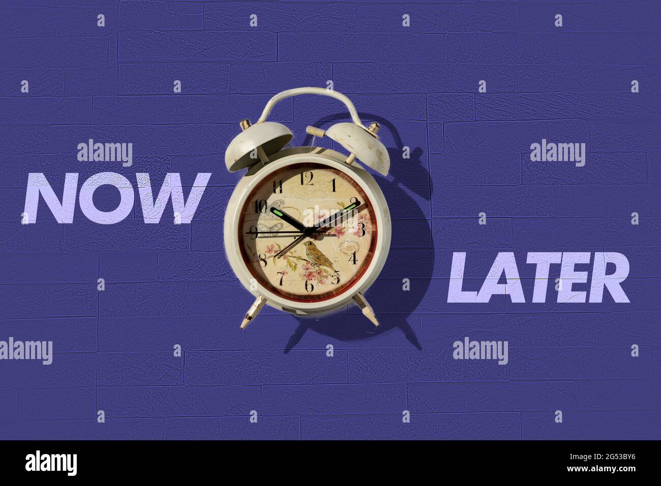 simple retro alarm clock on color background with words now and later ...