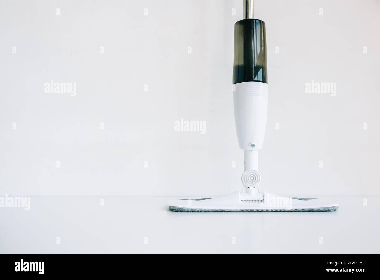 White mop with spray bottle isolated on white background with copy ...